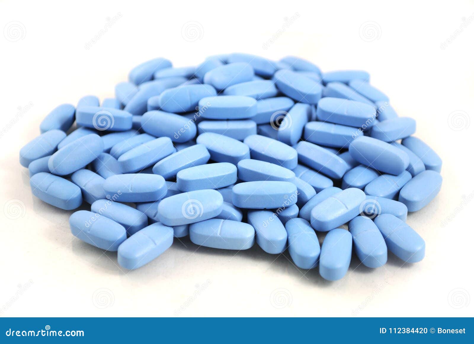 Bright blue oval tablets stock photo. Image of natural - 112384420