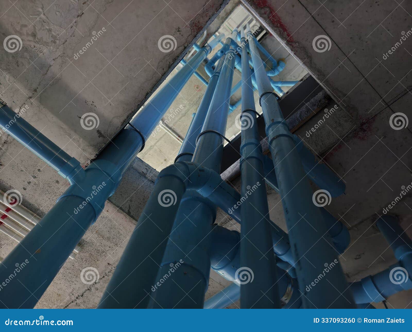 A Bright Blue Pipes Attached To a Solid Concrete Wall Stock Photo ...