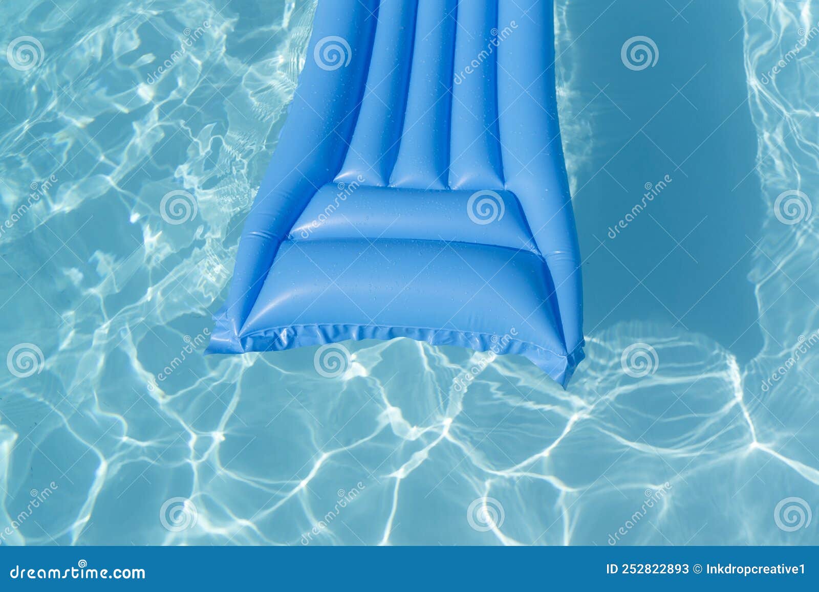 Bright Blue Summer Pool Lounger Float on a Rippled Swimming Pool Stock ...
