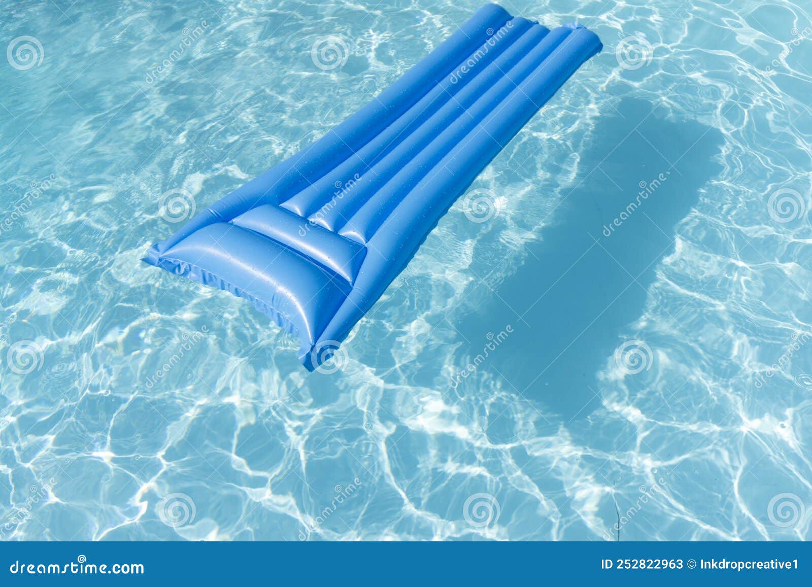Bright Blue Summer Pool Lounger Float on a Rippled Swimming Pool Stock ...