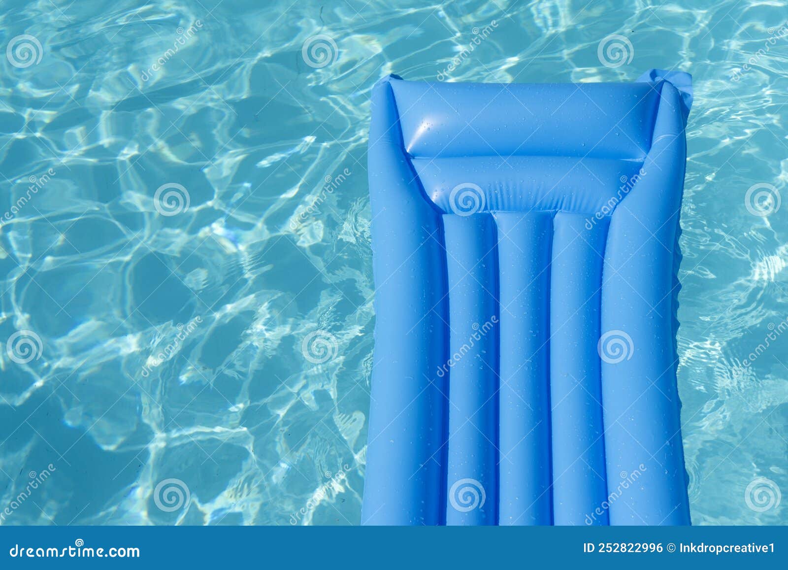 Bright Blue Summer Pool Lounger Float on a Rippled Swimming Pool Stock ...