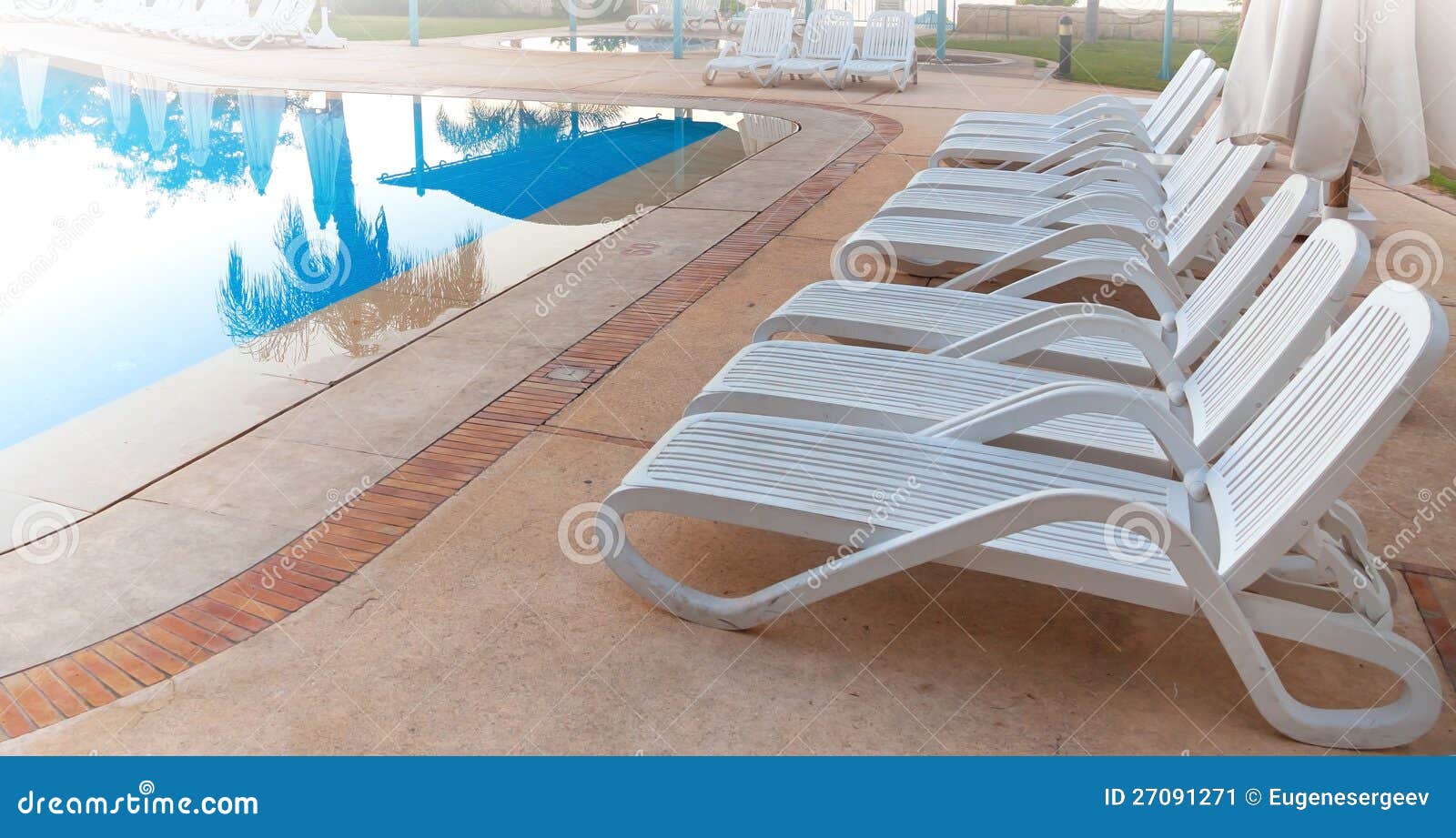 Bright Blue Swimming Pool and Empty Resting Chairs Stock Image - Image ...