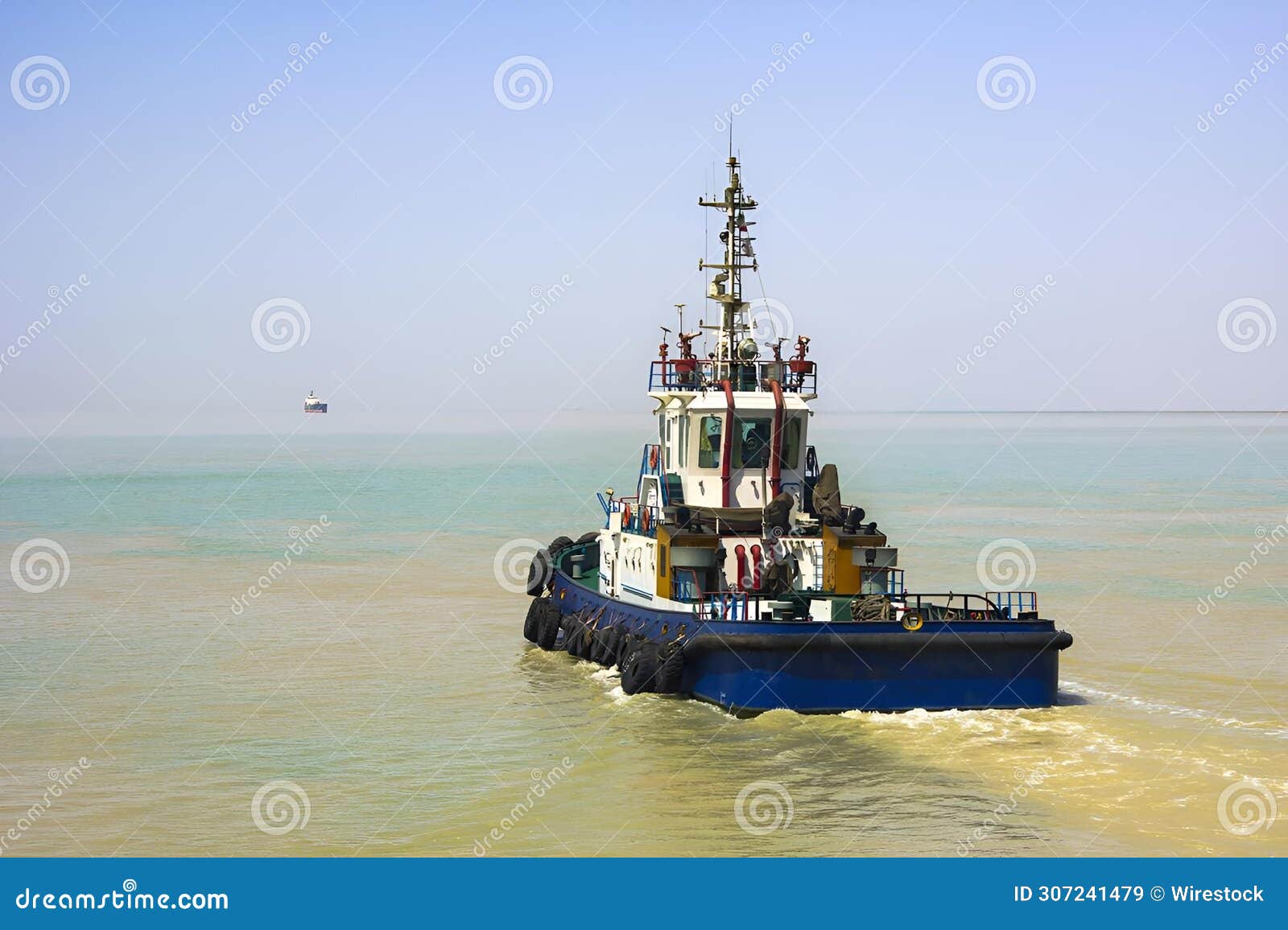 Bright Blue Tugboat Sails Along the Shoreline of a Sunny Day. Stock ...