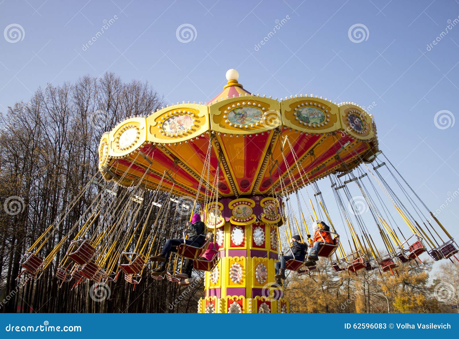 Bright Carousel with Chains Spinning Around in the Park with the ...