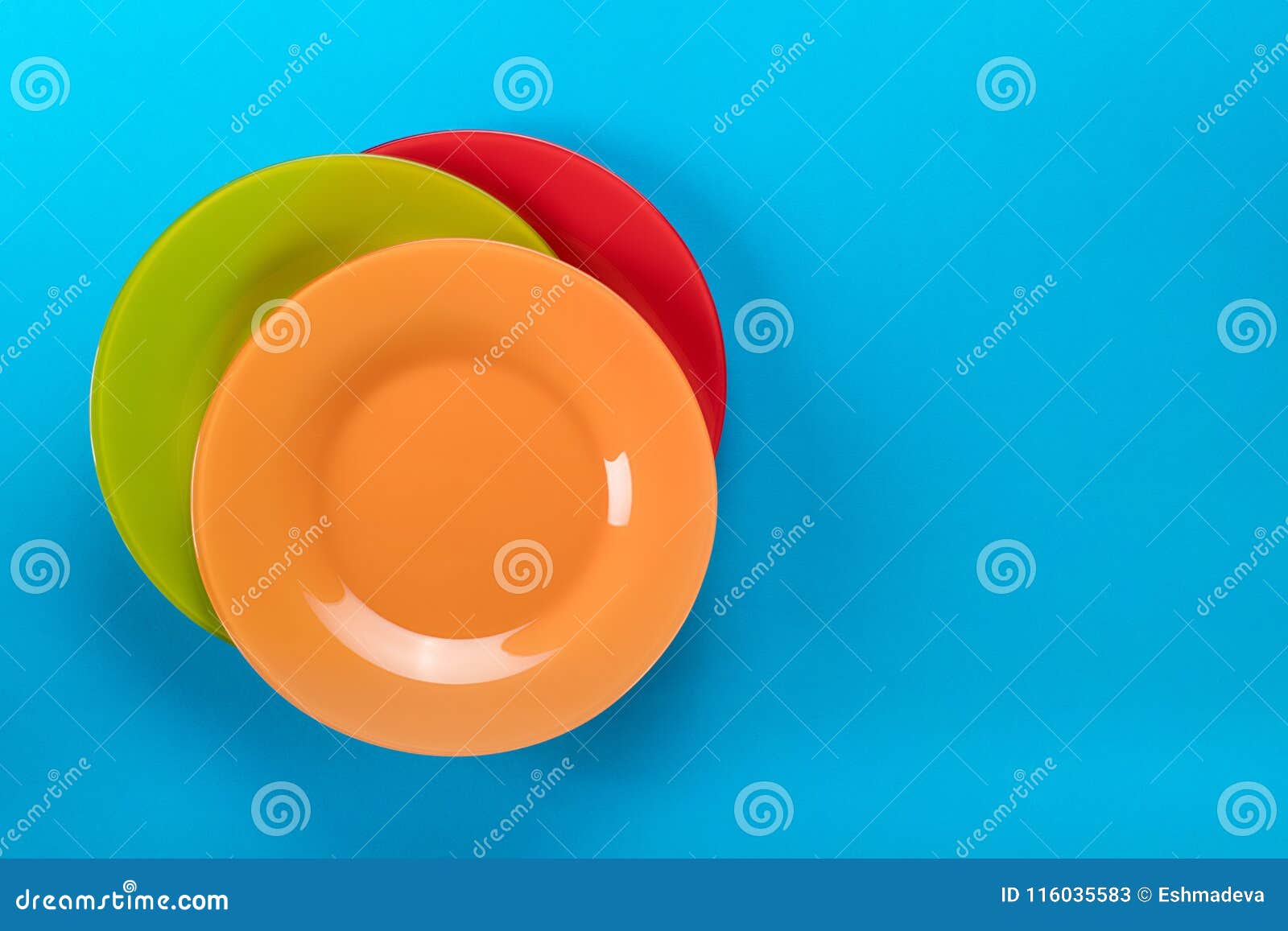 Bright Colored Plates on Blue Background Stock Image - Image of table ...