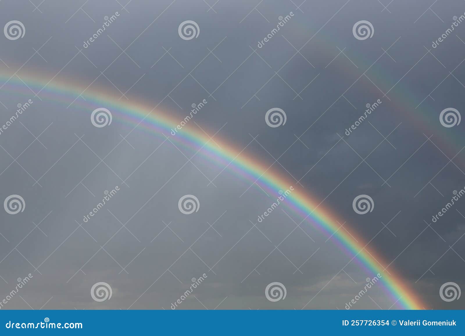 Bright Double Rainbow with Dark Rain Clouds in the Nature Background ... Bright Double Rainbow with Dark Rain Clouds in the Nature Background ...