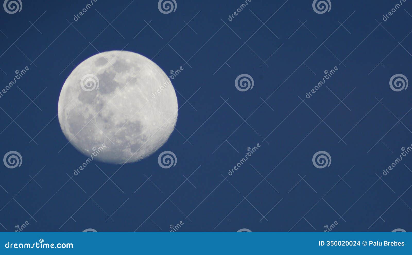 A Bright Full Moon Shining in a Dark Blue Night Sky Surrounded by Soft ...