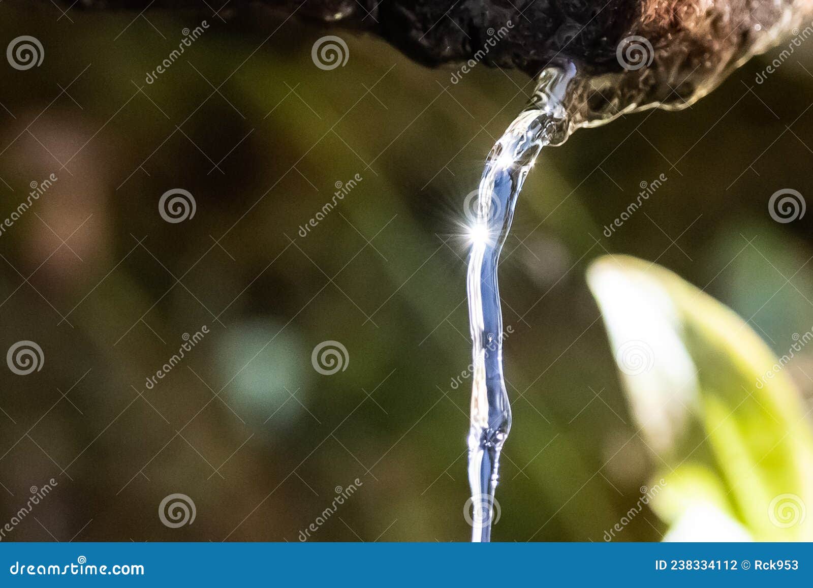 Bright Glint of Sunlight Reflecting from a Thin Stream of Water Stock ...