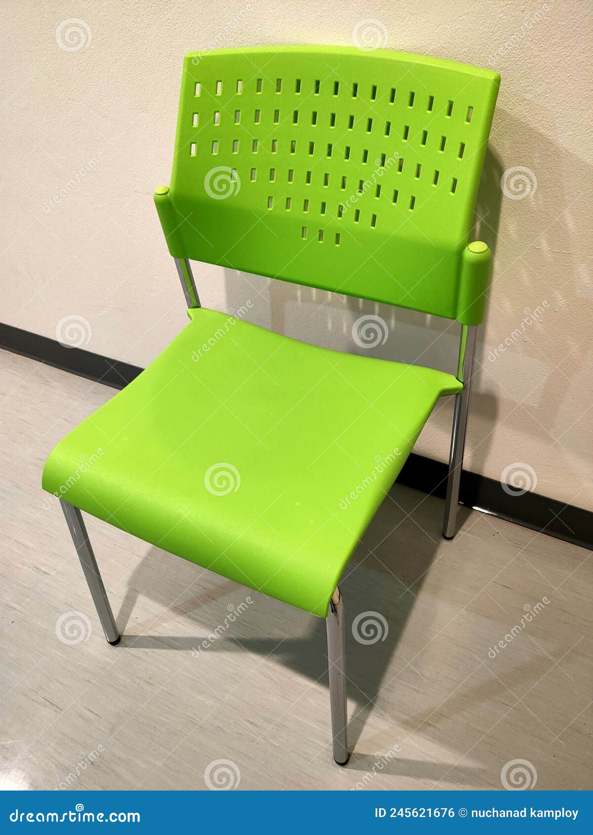 A Bright Green Plastic Chair Had a Backrest in an Empty Room. Stock ...