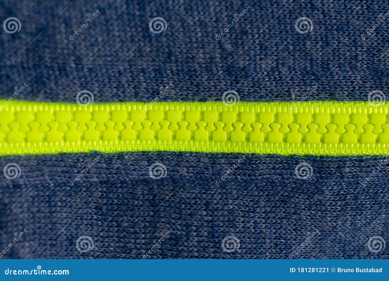 Bright Green Plastic Zipper on a Blue Fabric Texture, Going from Left ...