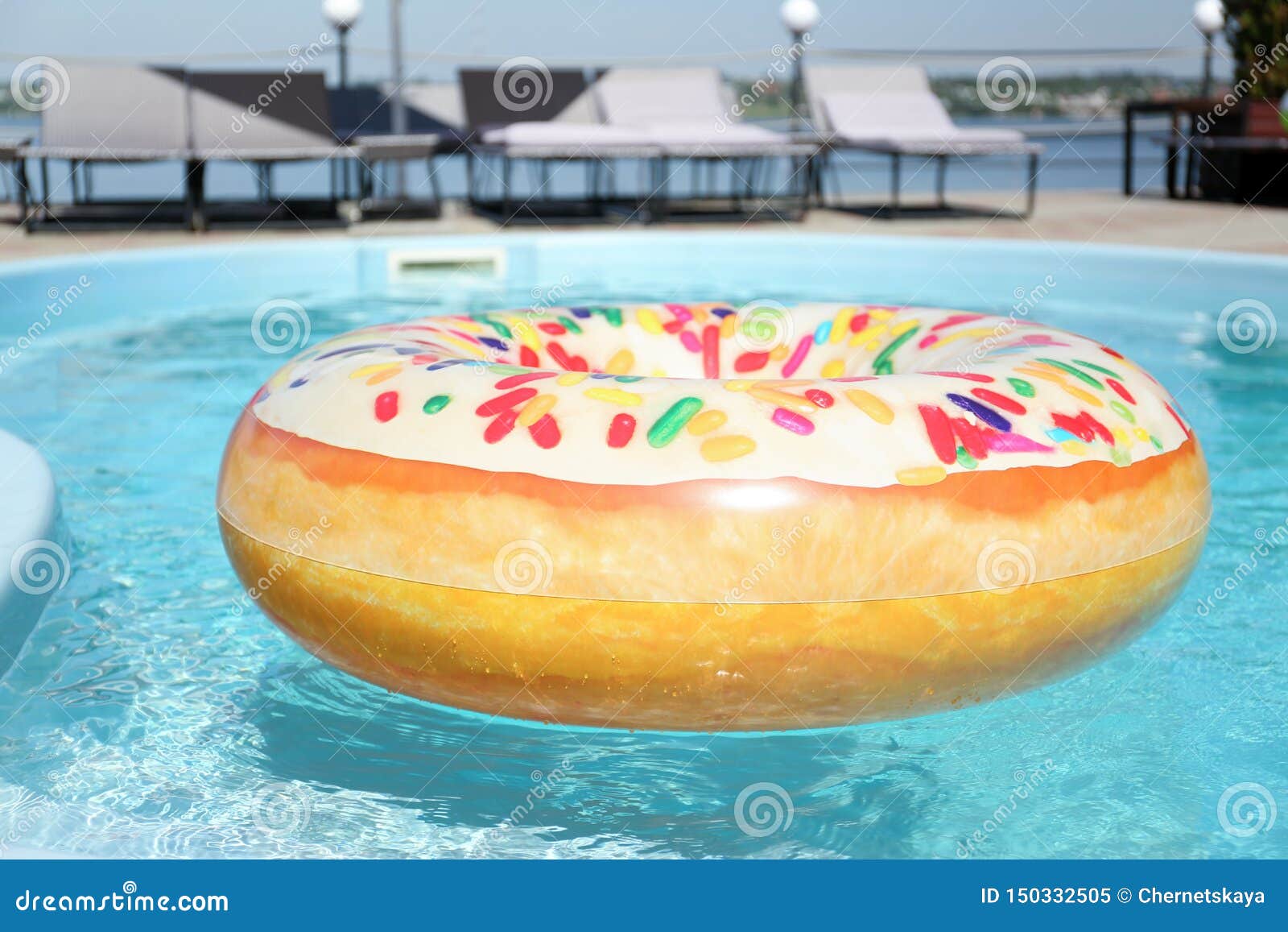 Bright Inflatable Doughnut Ring Floating in Swimming Pool on Sunny Day ...