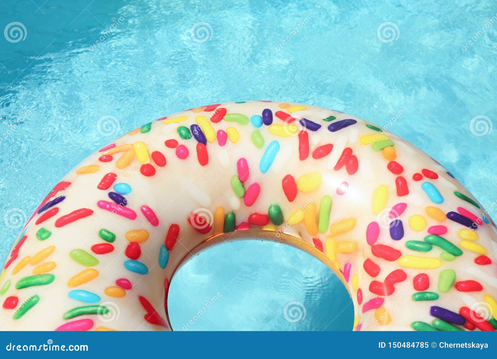 Bright Inflatable Doughnut Ring Floating in Swimming Pool on Sunny Day ...