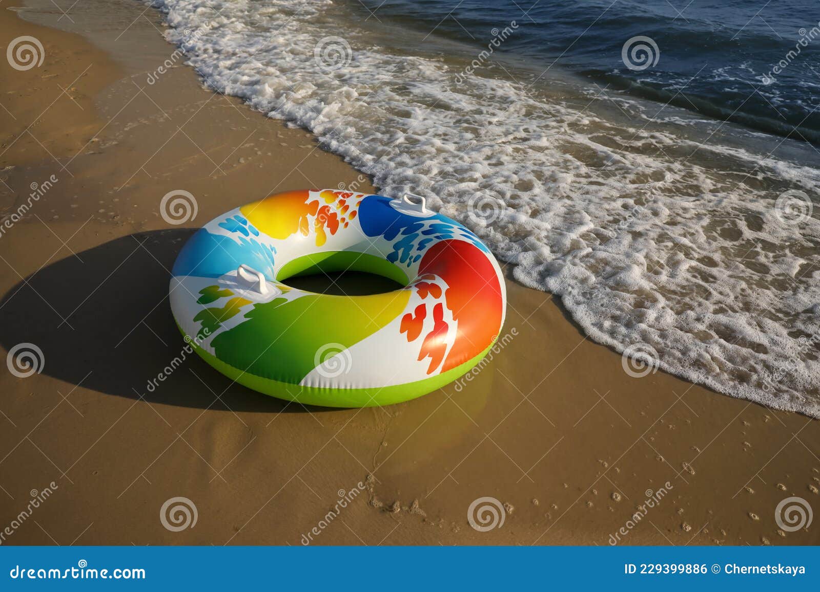 Bright Inflatable Ring on Sandy Beach Near Sea, Space for Text Stock ...