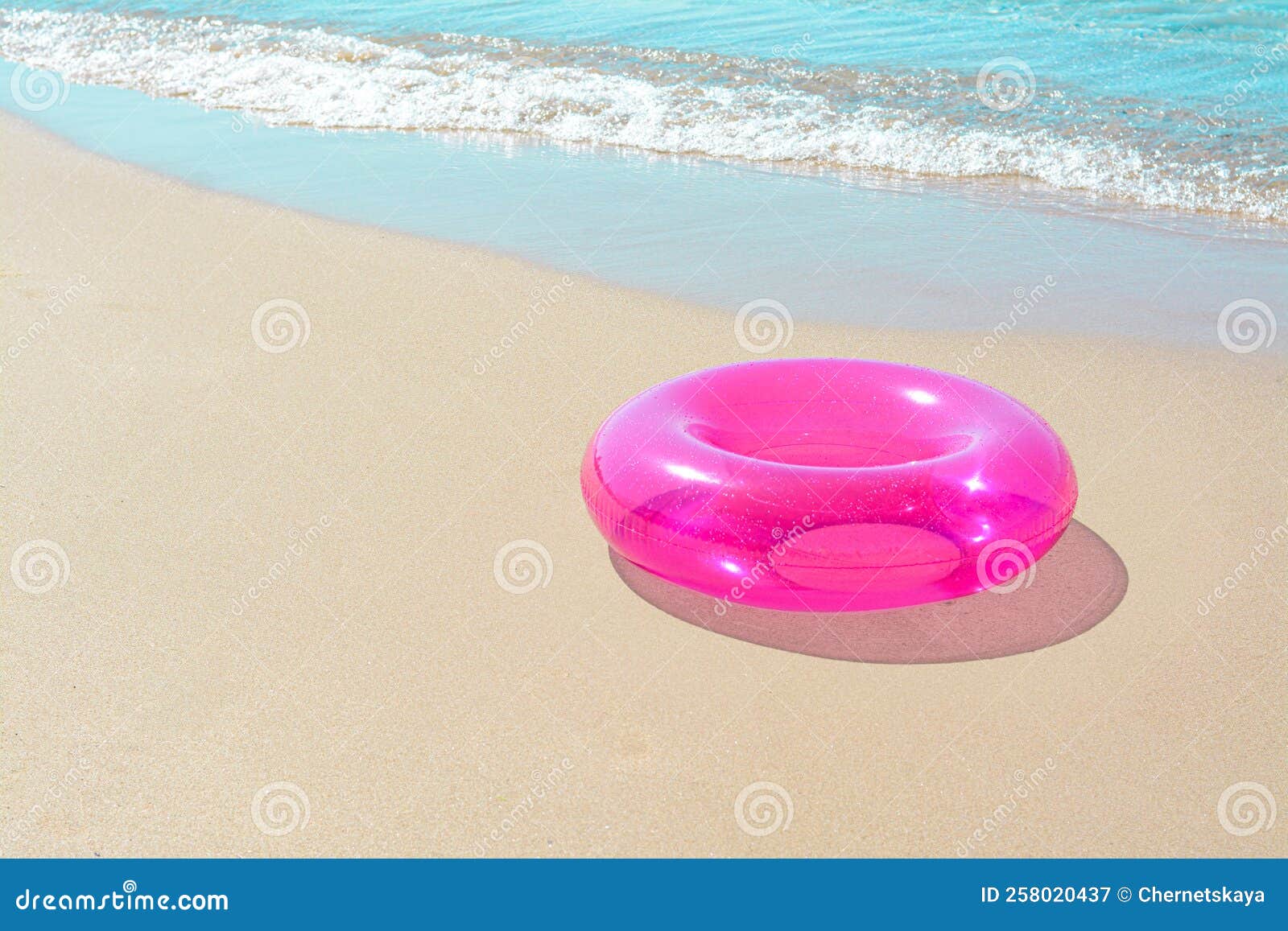 Bright Inflatable Ring on Sandy Beach Near Sea. Space for Text Stock ...