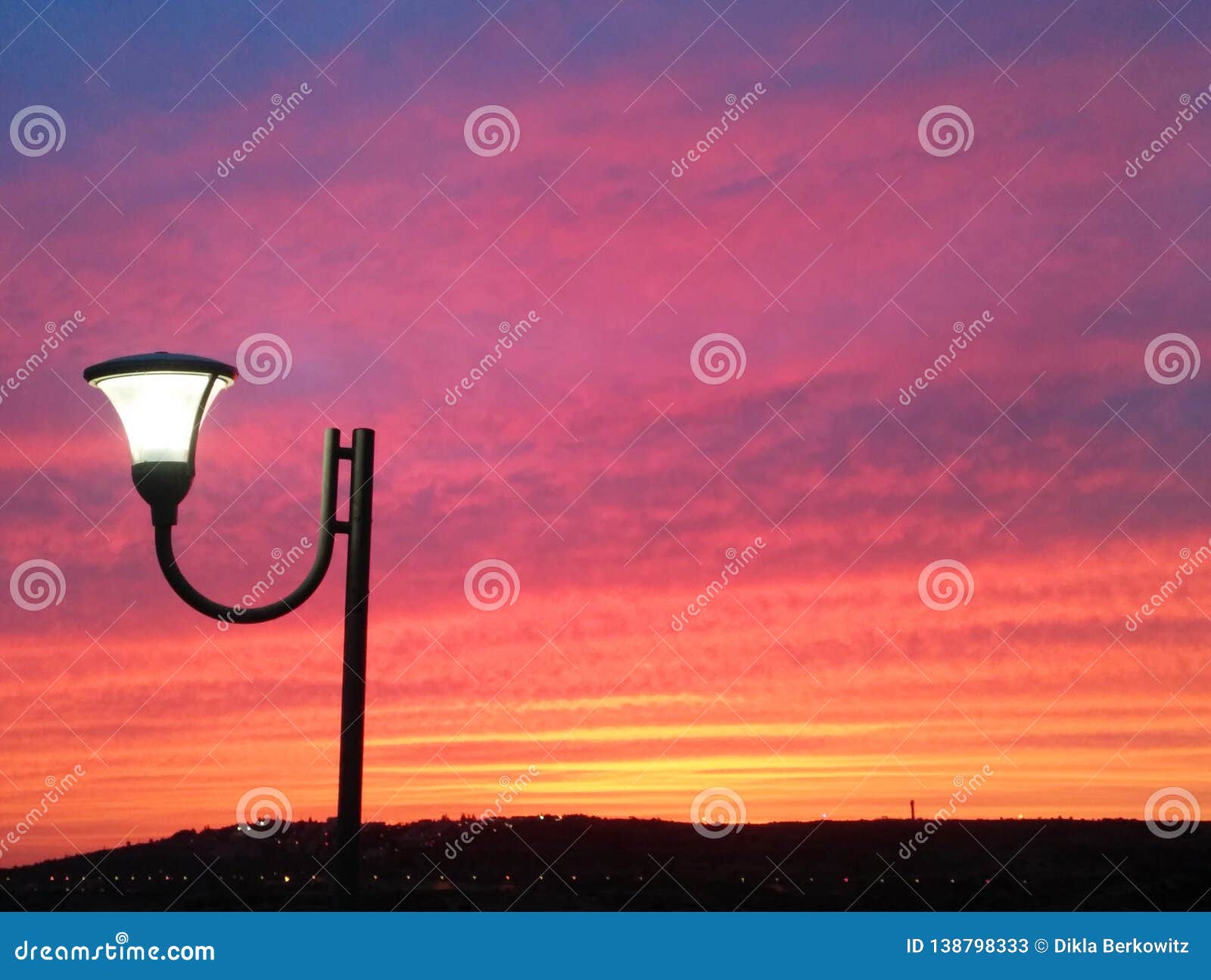 A Bright Lantern in Front with an Amazing Sunset in the Background ...