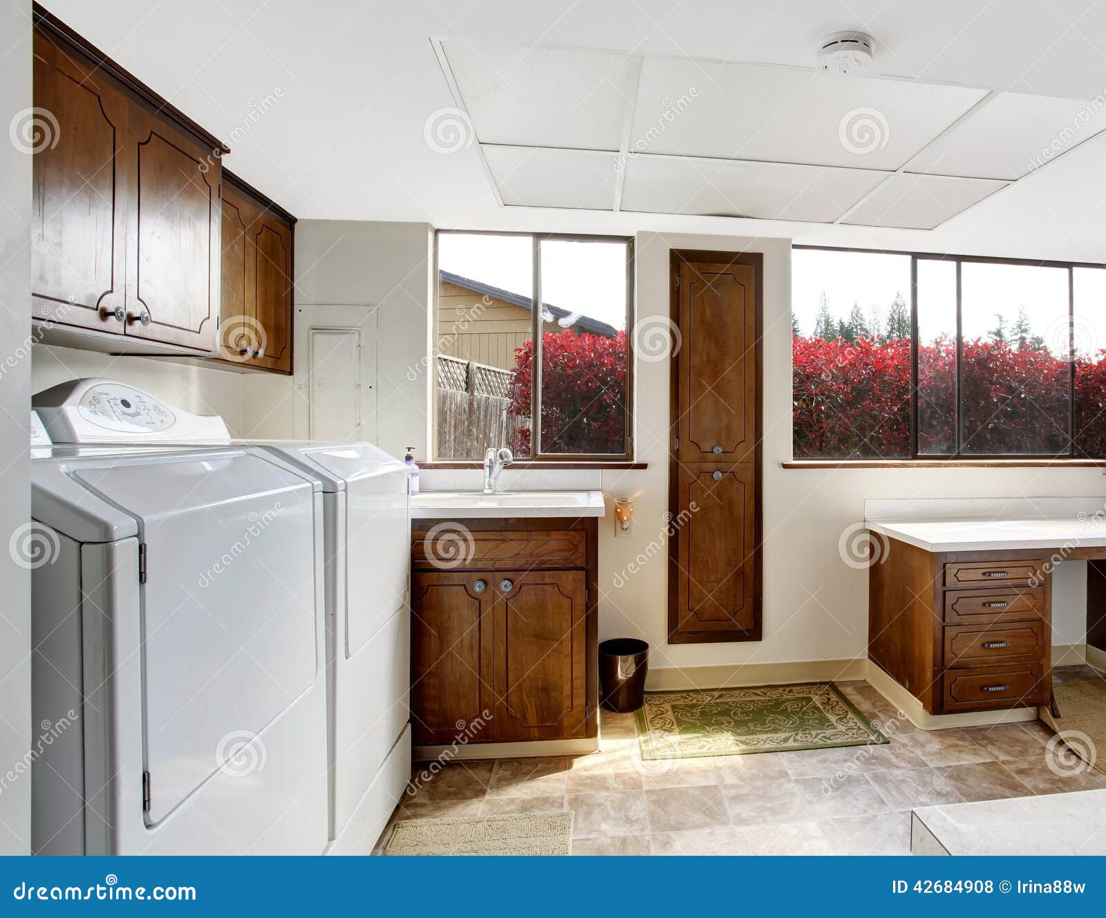 Bright Laundry Room with Dark Brown Cabinets Stock Photo - Image of ...