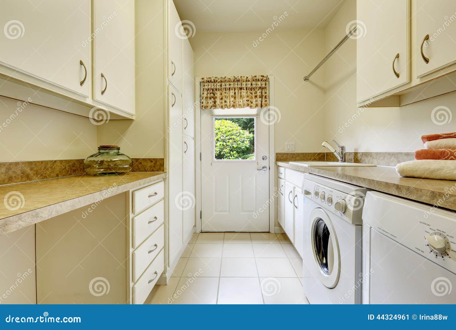 Bright Laundry Room with White Cabinets Stock Image - Image of dryer ...