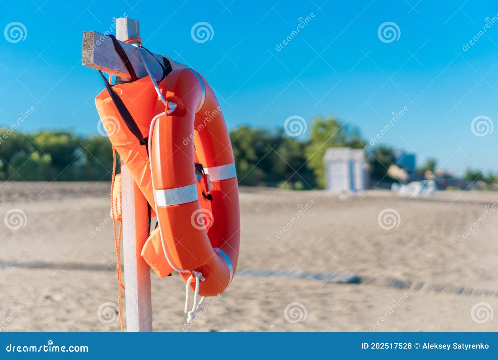Bright Lifebuoy and Life Jacket on the Beach Stock Photo - Image of ...