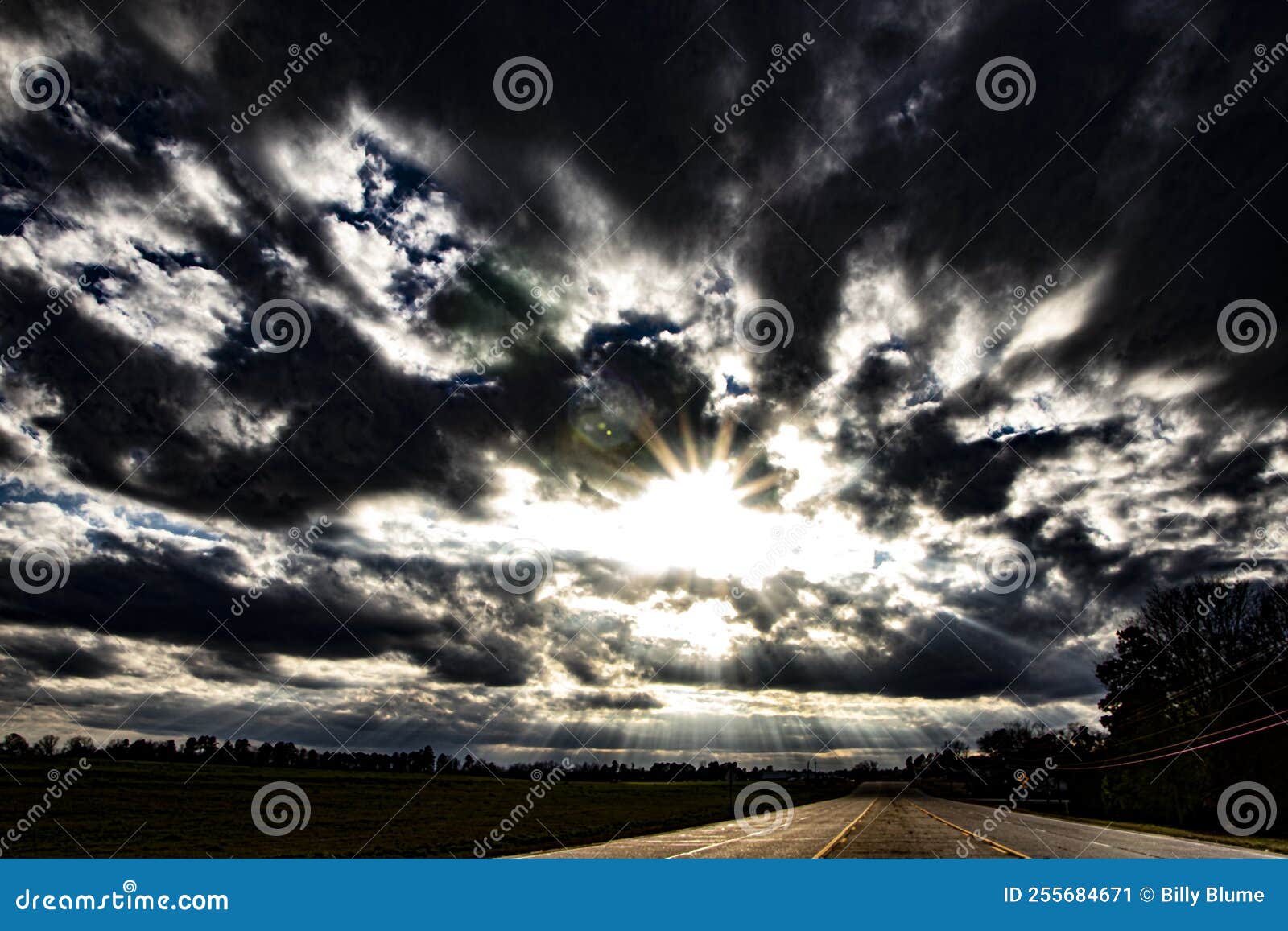 Bright Light Beaming through Clouds Dim Light on a Rural Road in the ...