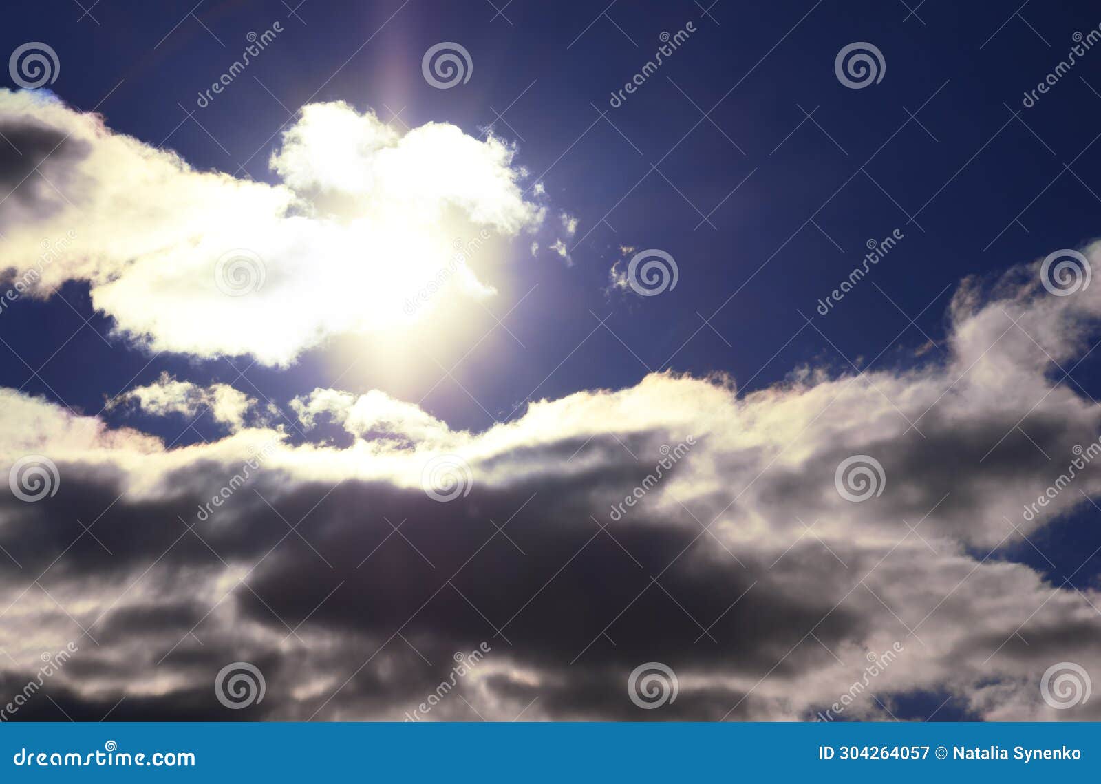 Bright Light of the Sun on a Dark Blue Sky among the Clouds Stock Image ...