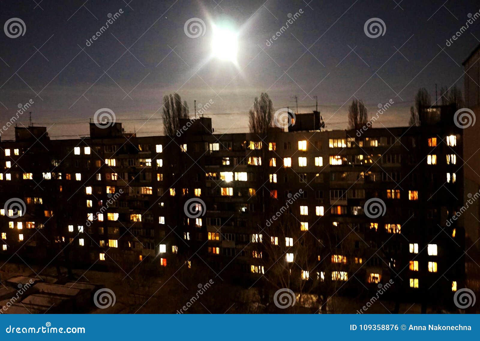 A Bright Moon Over the House, with Luminous Windows. Stock Photo ...