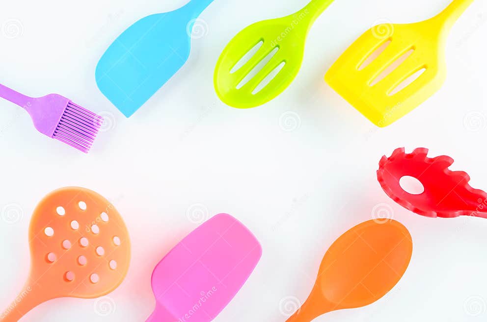 Bright Multi Colored Kitchen Utensils on White Background with Copy ...