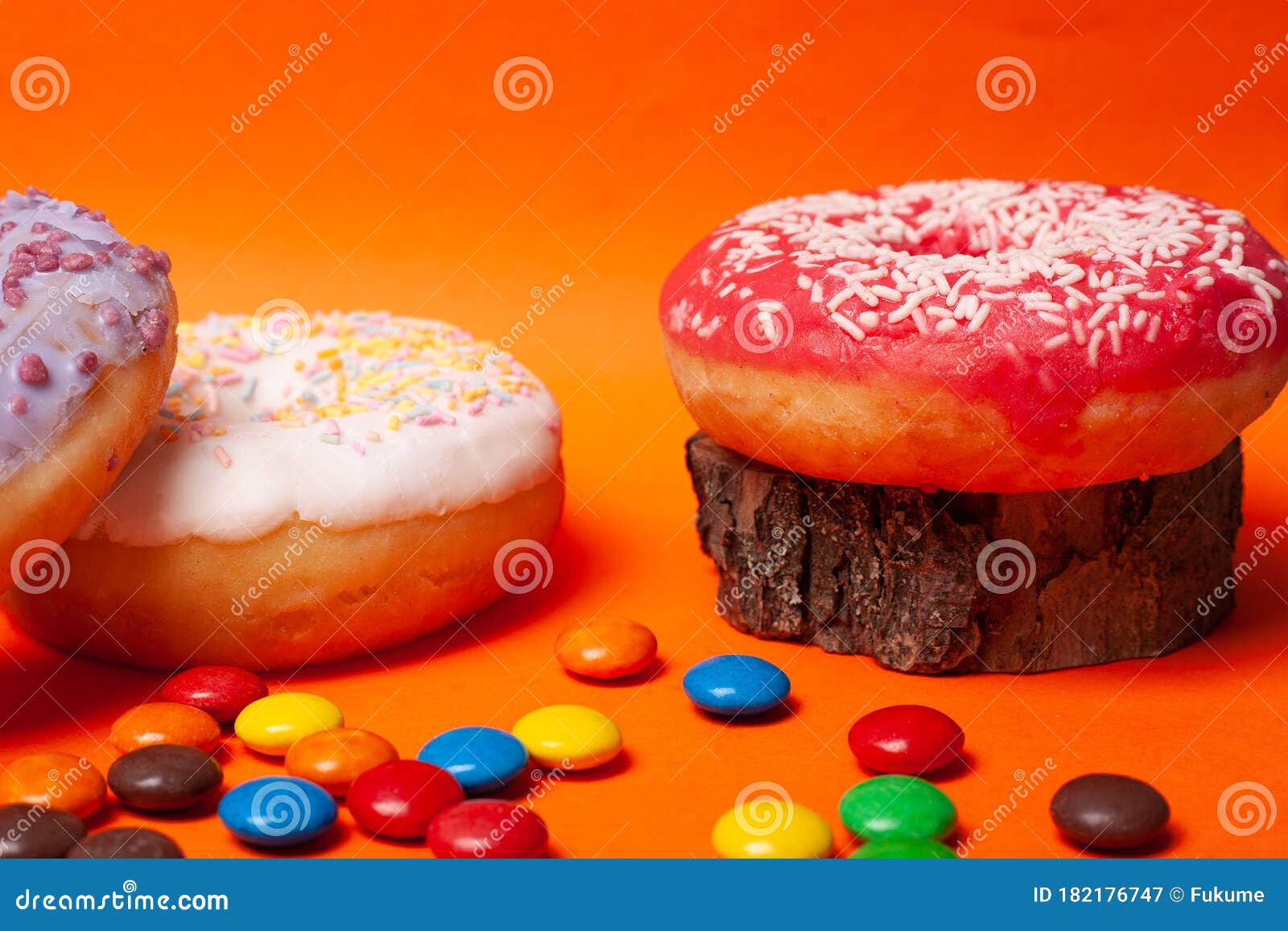 Bright Multi-colored Sweets on an Orange Background. Assorted Donuts ...