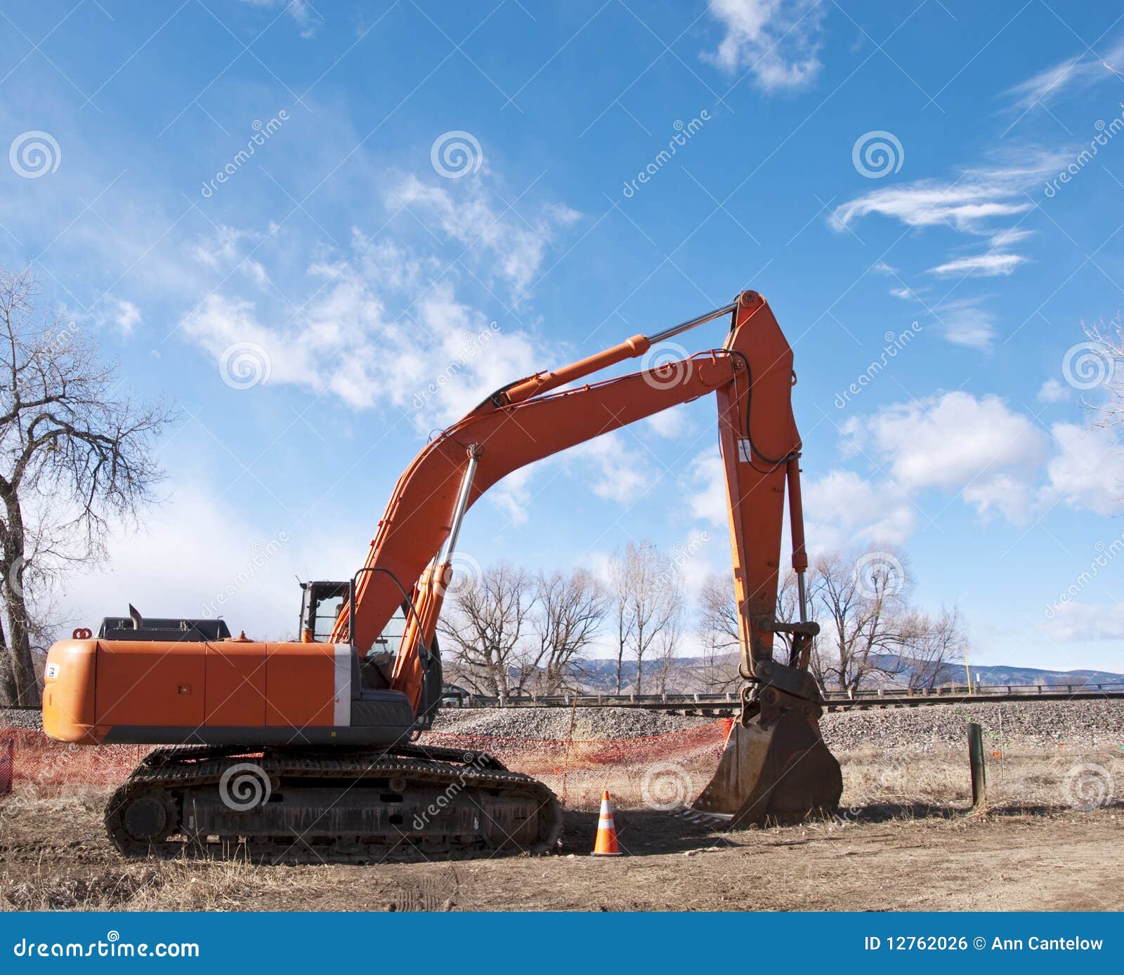 Bright Orange Backhoe in a Rural Area Stock Photo - Image of building ...