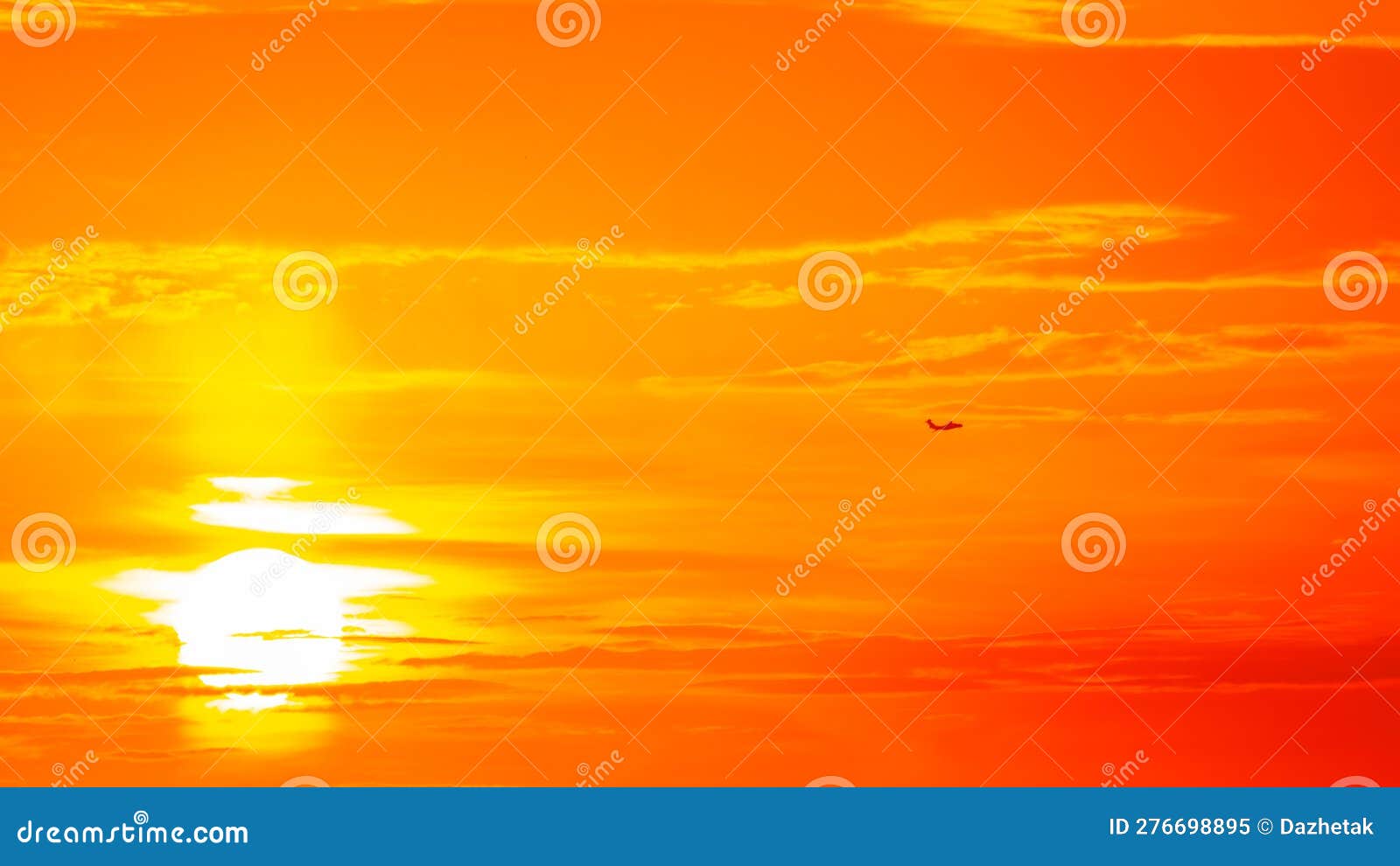 A Bright Orange Sky, the Silhouette of a Flying Plane and a Bright Sun ...