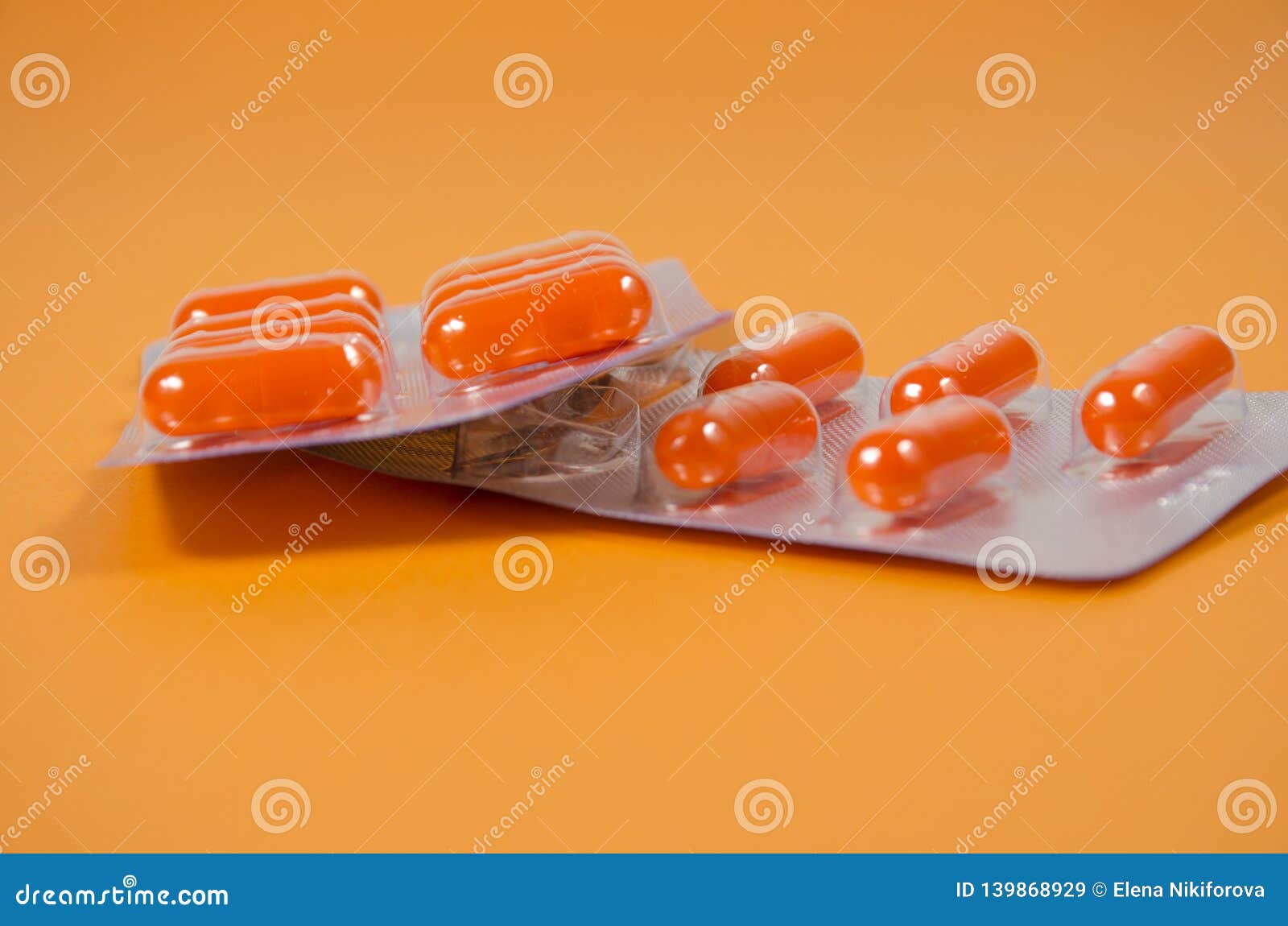 Bright Orange Tablets in Silver Packaging on an Orange Background Stock ...