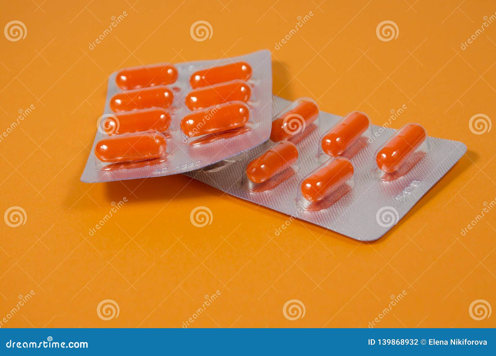 Bright Orange Tablets in Silver Packaging on an Orange Background Stock ...