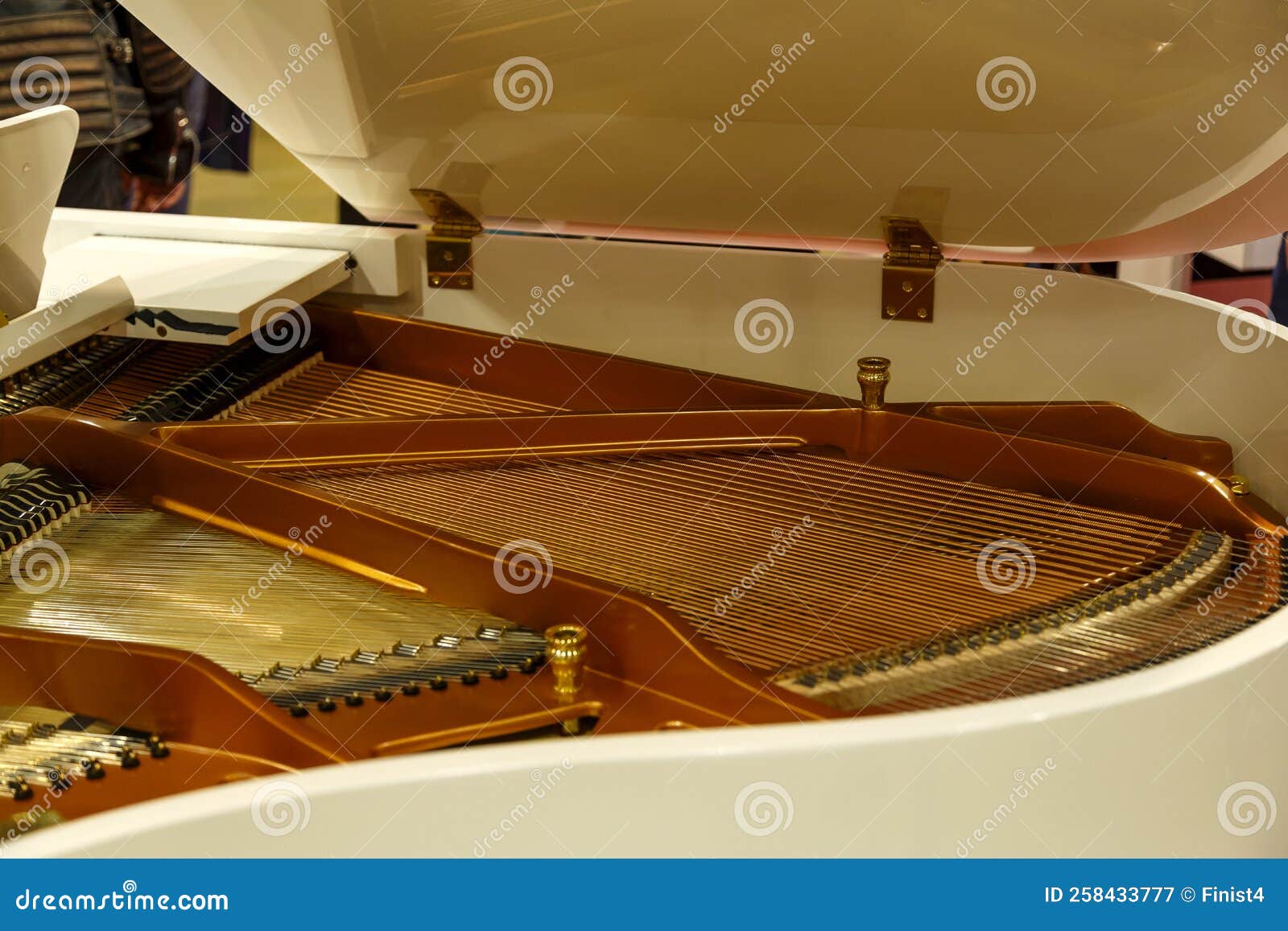 A Bright Piano with an Open Lid Shows the Strings and the Rest of the ...