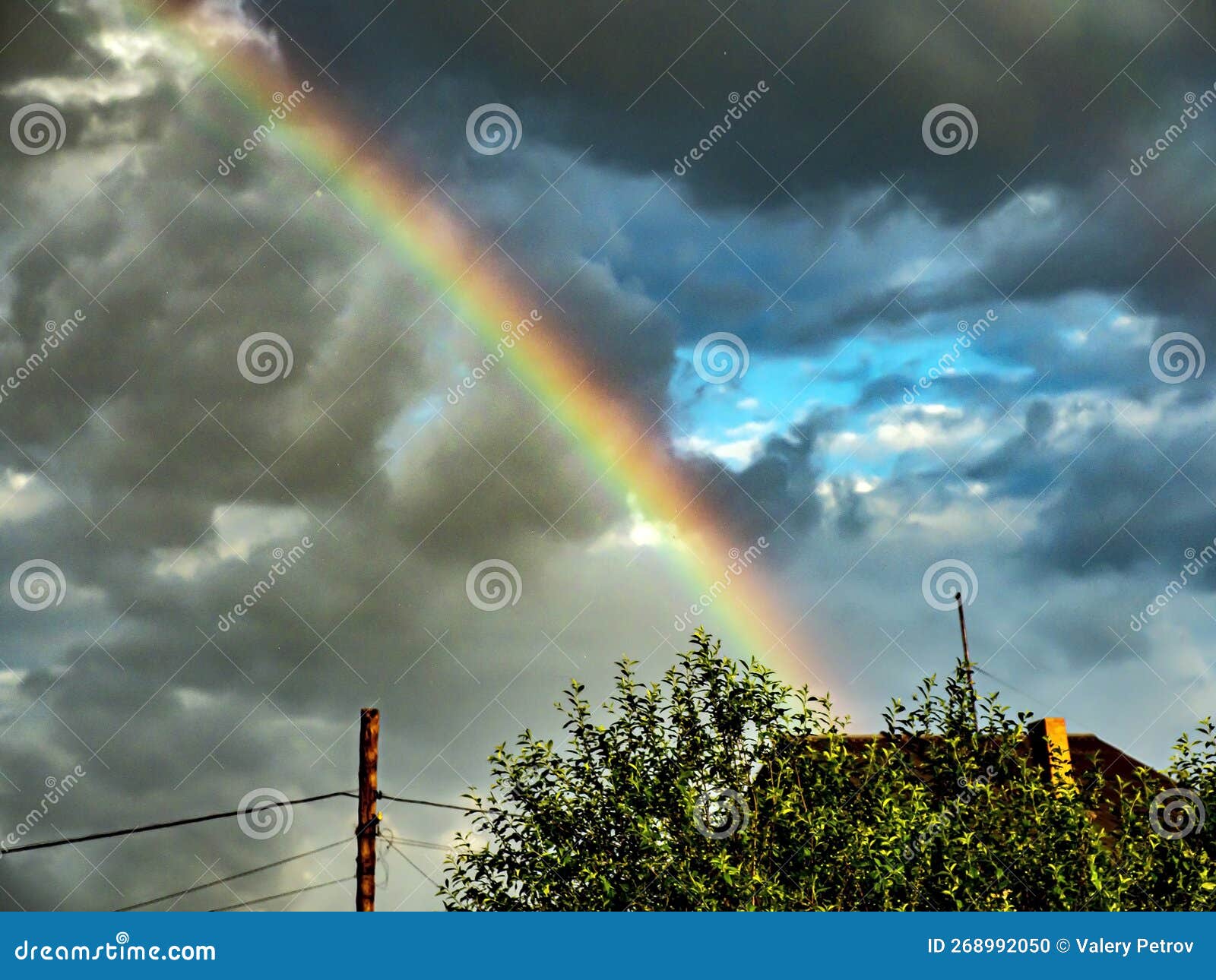 Bright Rainbow in a Cloudy Sky during Rain Stock Photo - Image of ...