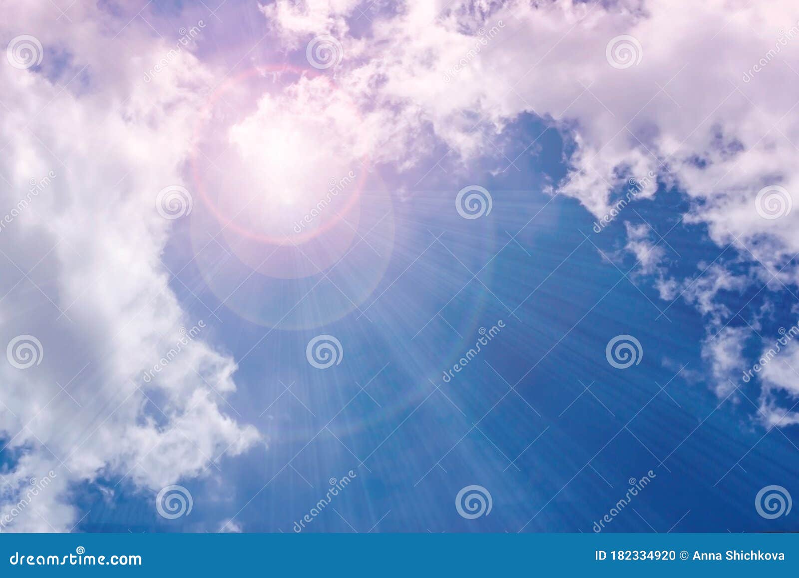 A Bright Ray of Sunshine Breaks through the Fluffy White Clouds. the ...