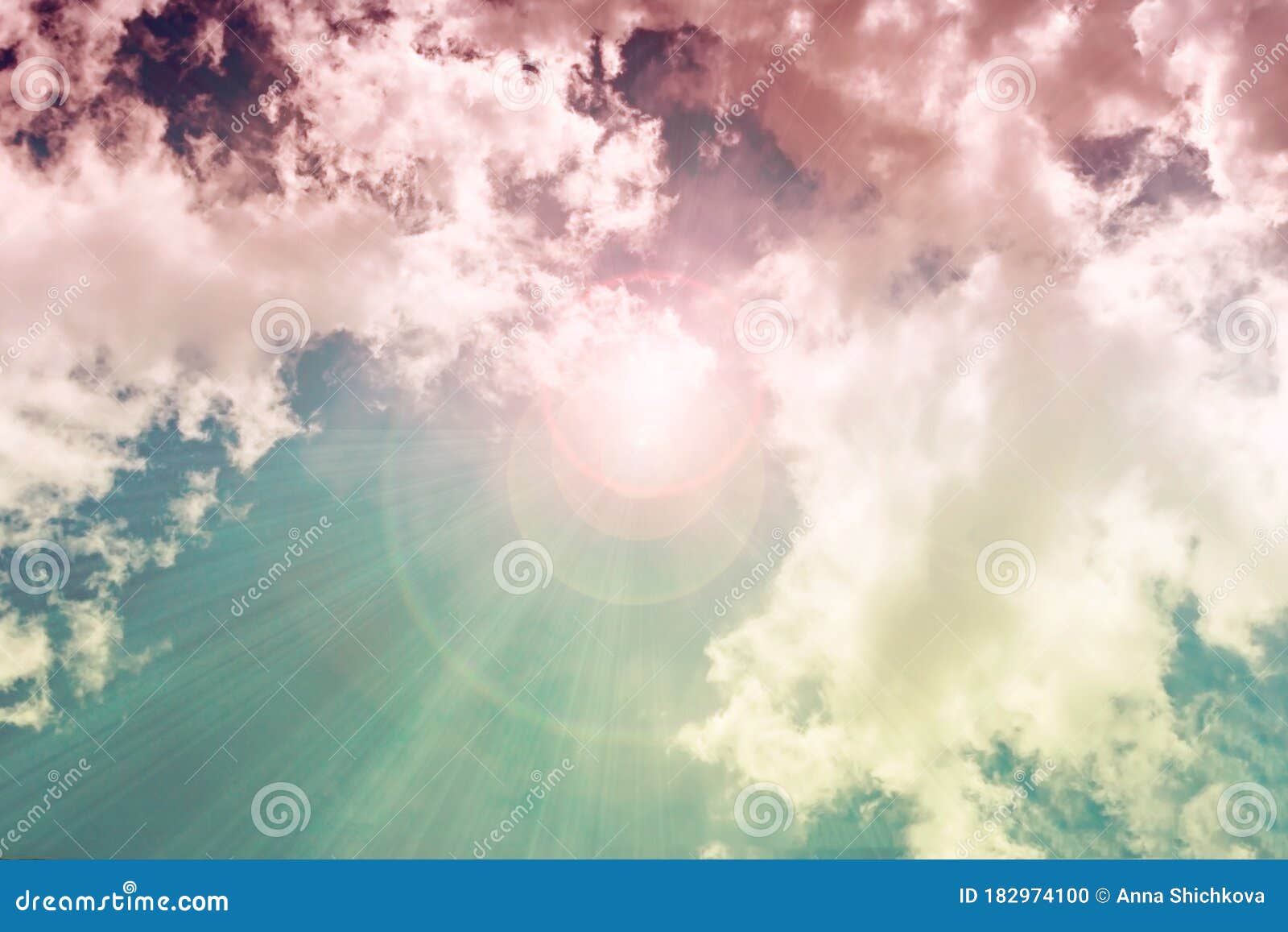 A Bright Ray of Sunshine Breaks through the Fluffy White Clouds. the ...