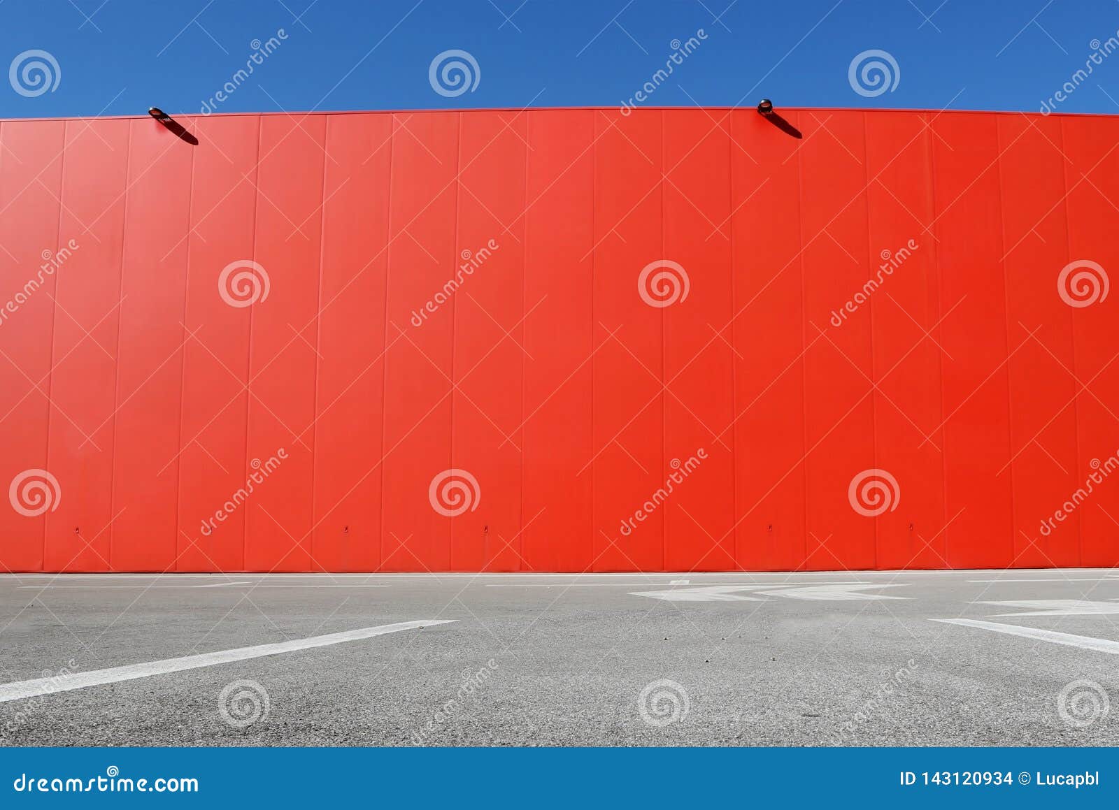 Bright Red Aluminium Cladding Wall with an Asphalt Road in Front ...