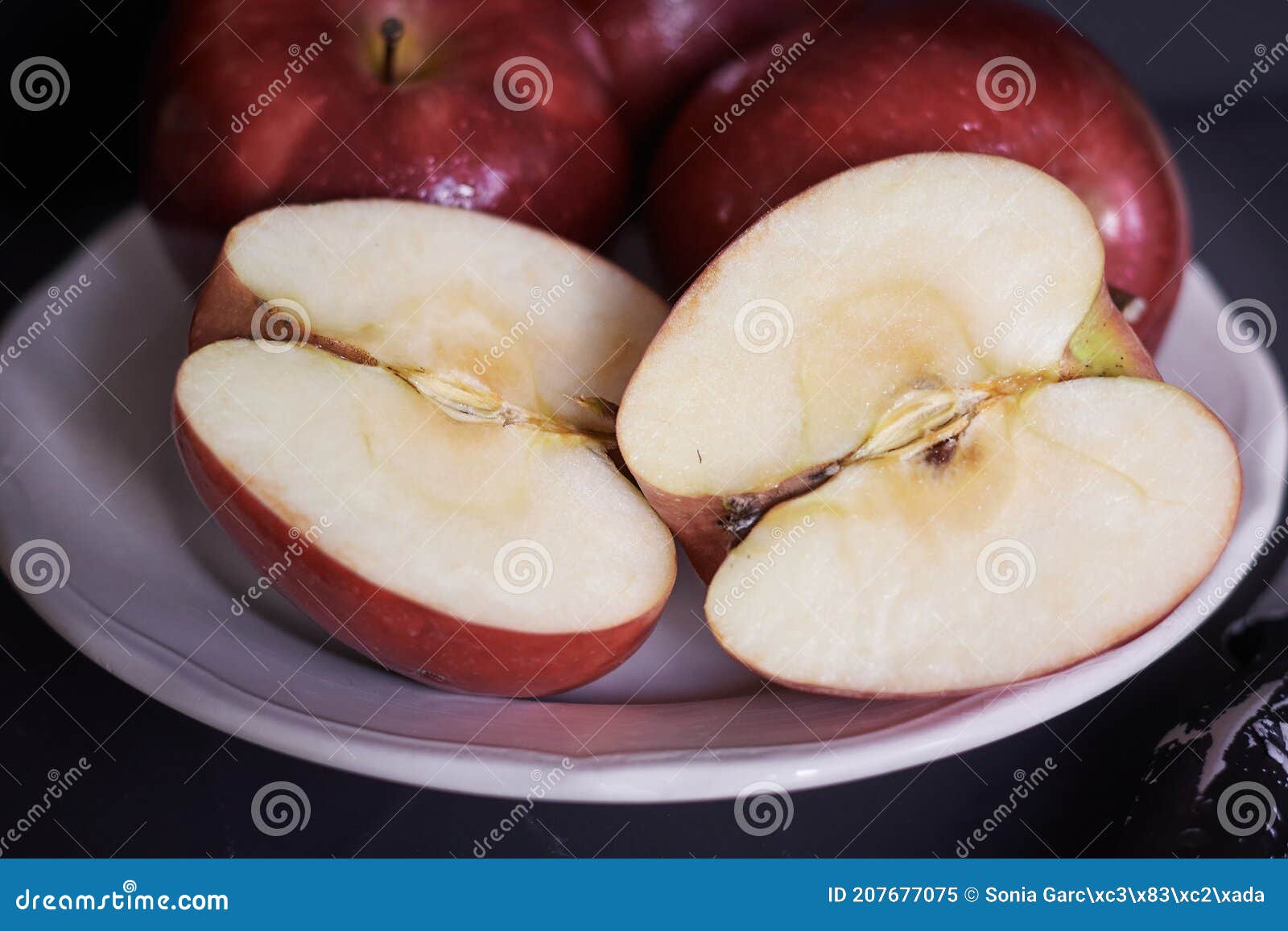 Bright Red Apples Split in Half in a White Ceramic Plate Stock Image ...