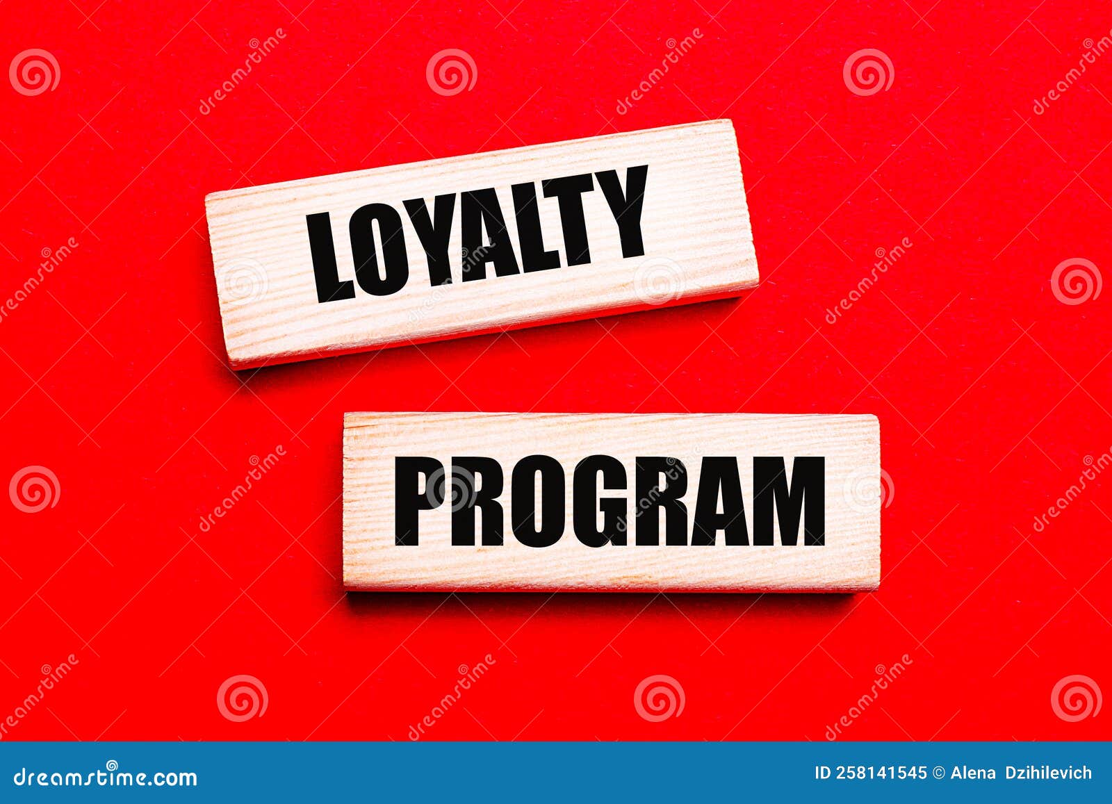 On a Bright Red Background, There are Two Light Wooden Blocks with the ...