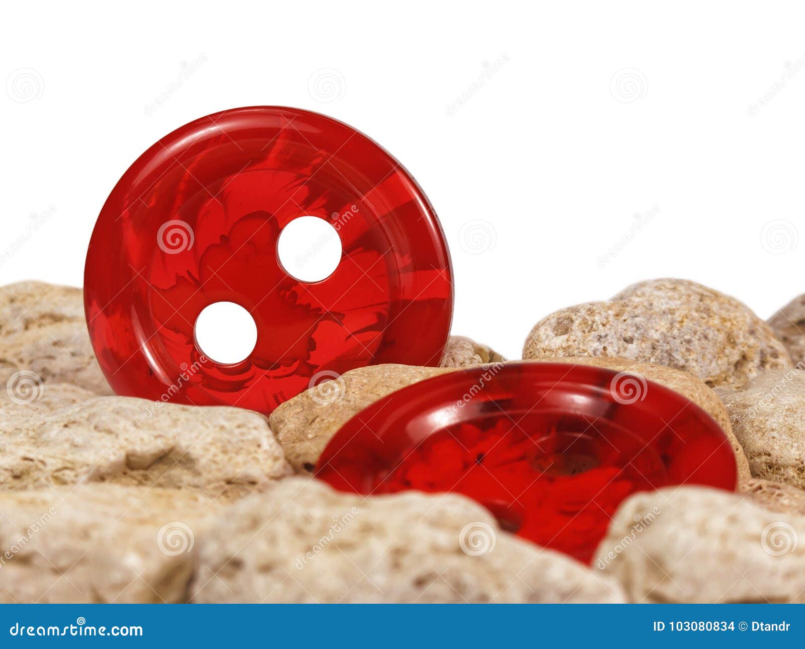 Red buttons among stones stock photo. Image of pile - 103080834