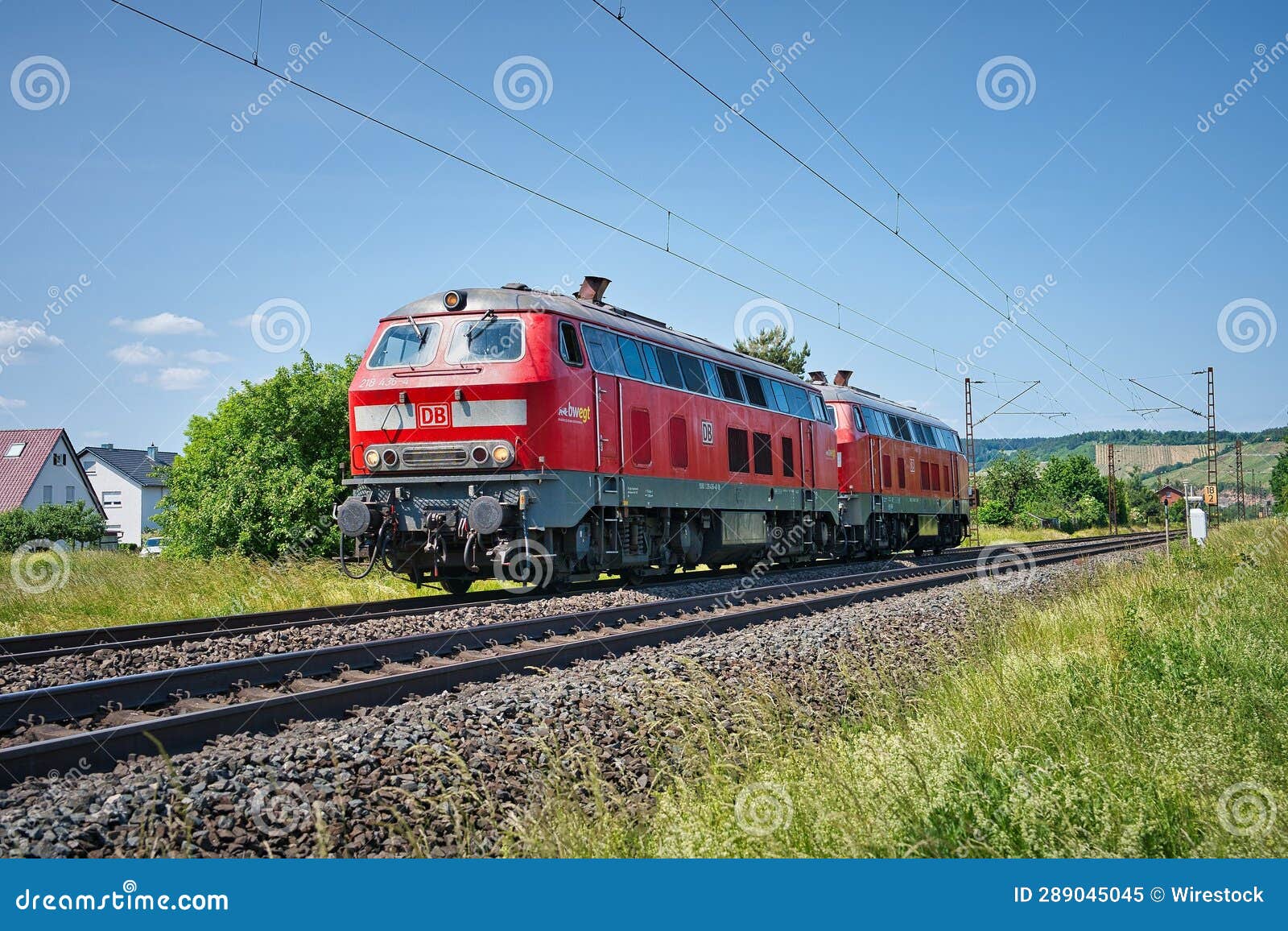 Bright Red Commuter Train Travelling Down the Railroad Tracks ...