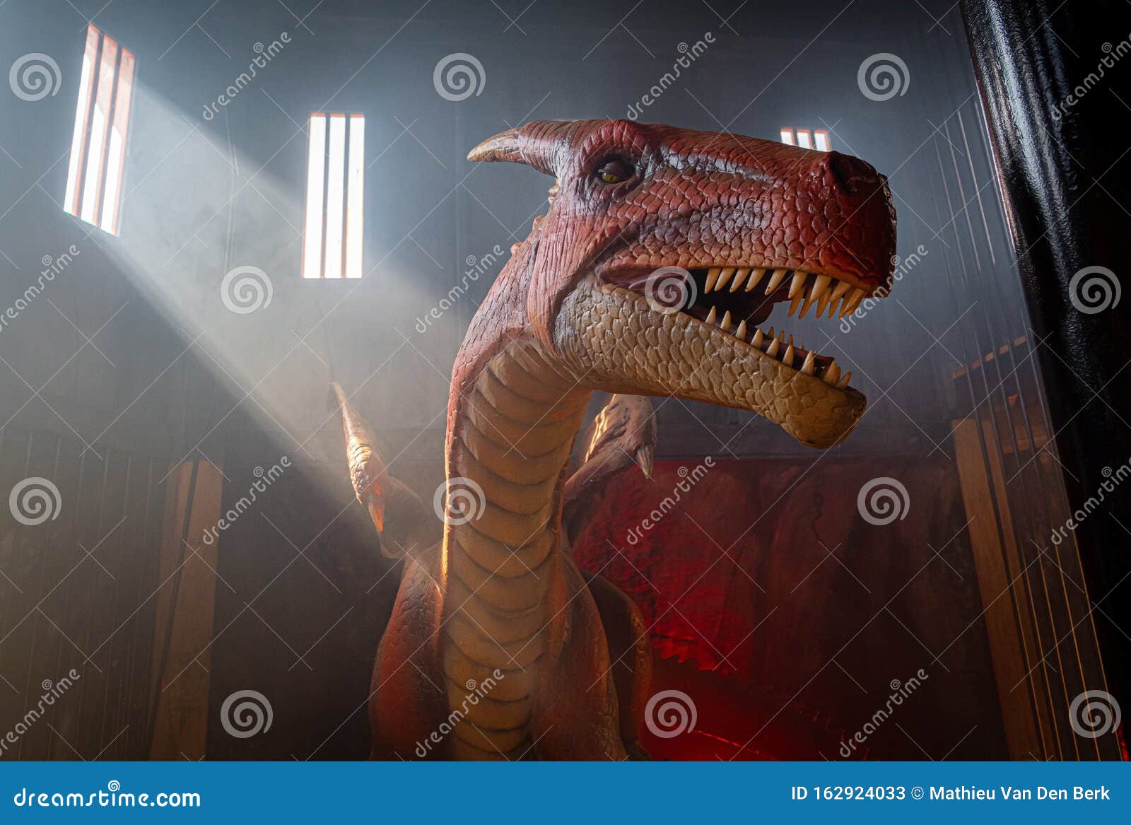 Bright Red Dragon in a Dungeon in England with Rays of Light through ...