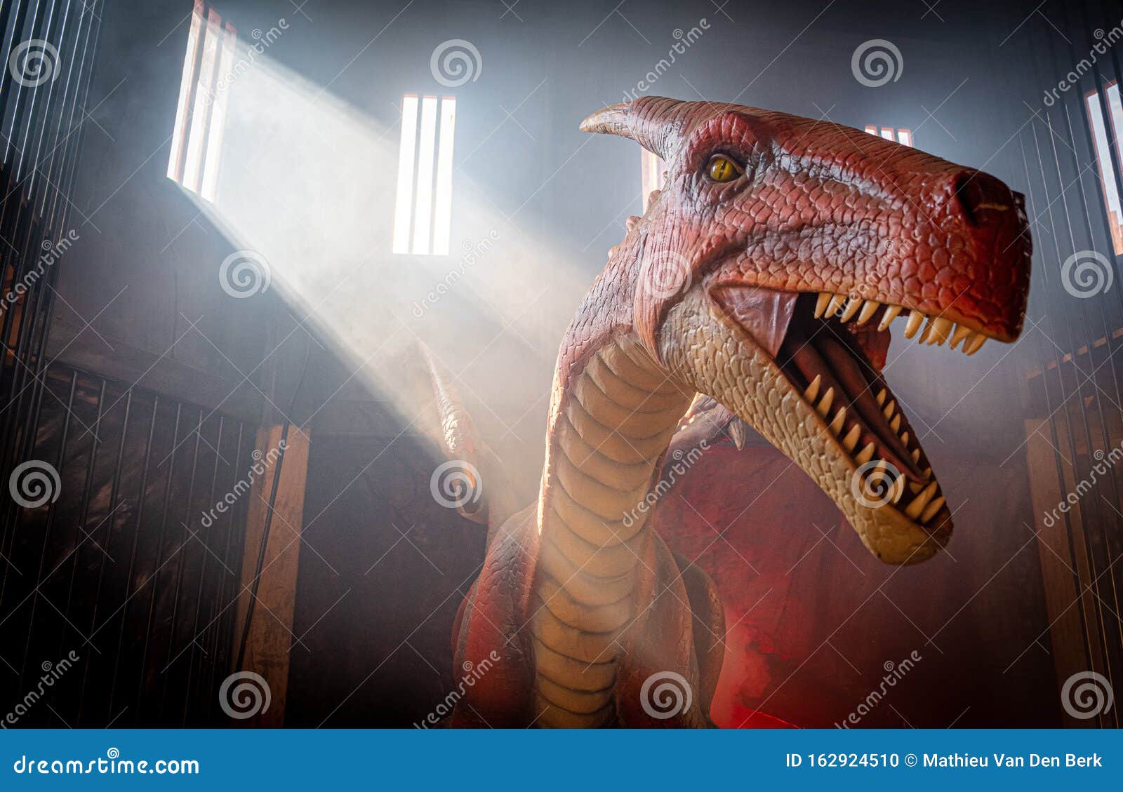 Bright Red Dragon in a Dungeon in England with Rays of Light through ...