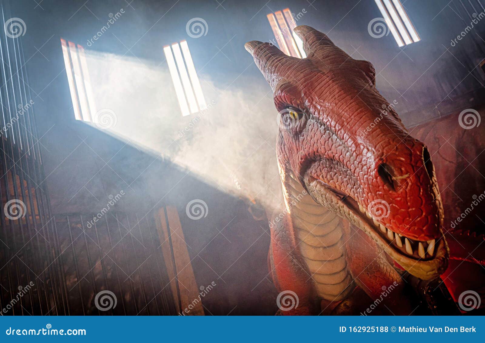 Bright Red Dragon in a Dungeon in England with Rays of Light through ...