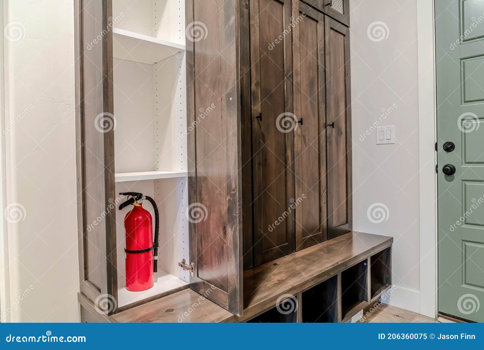 Bright Red Fire Extinguisher Inside the Shelf of a Cabinet Against ...