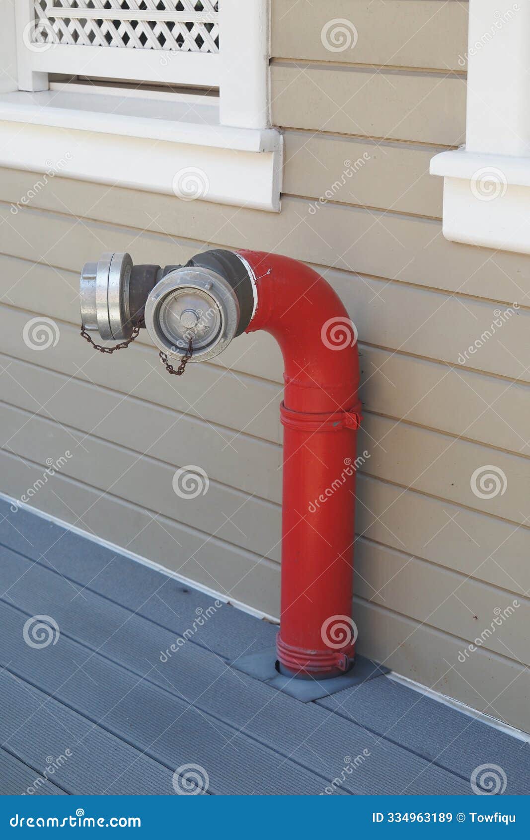 A Bright Red Fire Hydrant Attachment Installed on a Wooden Deck in an ...
