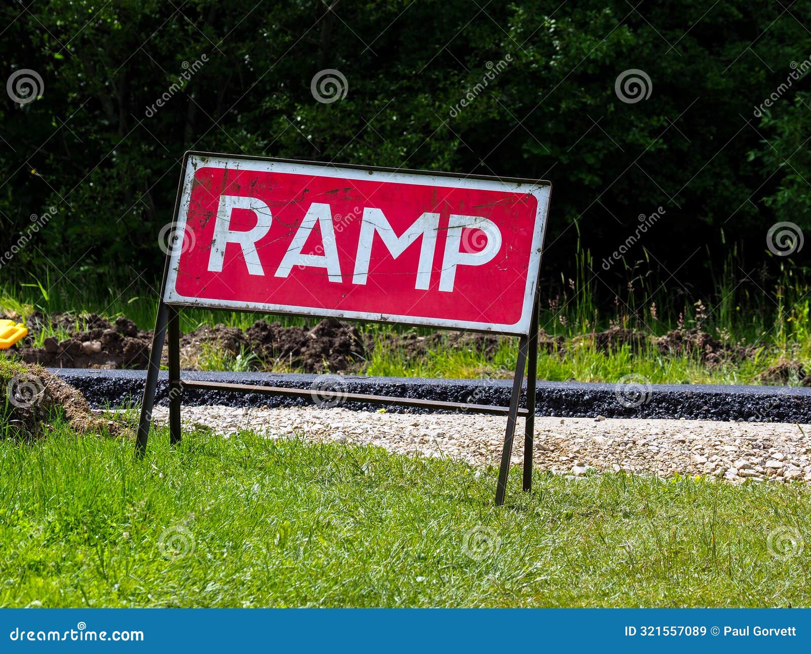 Bright Red RAMP Sign on a Grassy Construction Site, with Greenery in ...