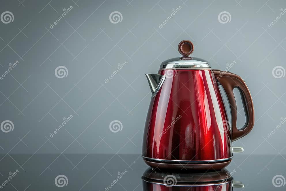 A Bright Red Tea Kettle Sits on a Table, Ready for Use Stock Photo ...