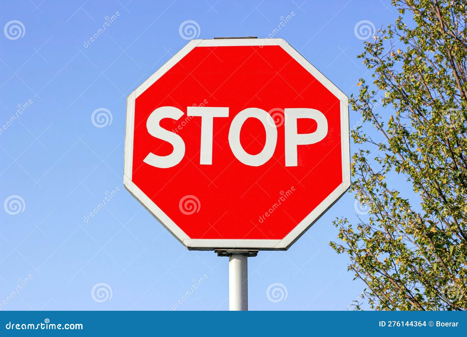 Bright Red and White Stop Traffic Sign Against the Blue Sky. Stock ...