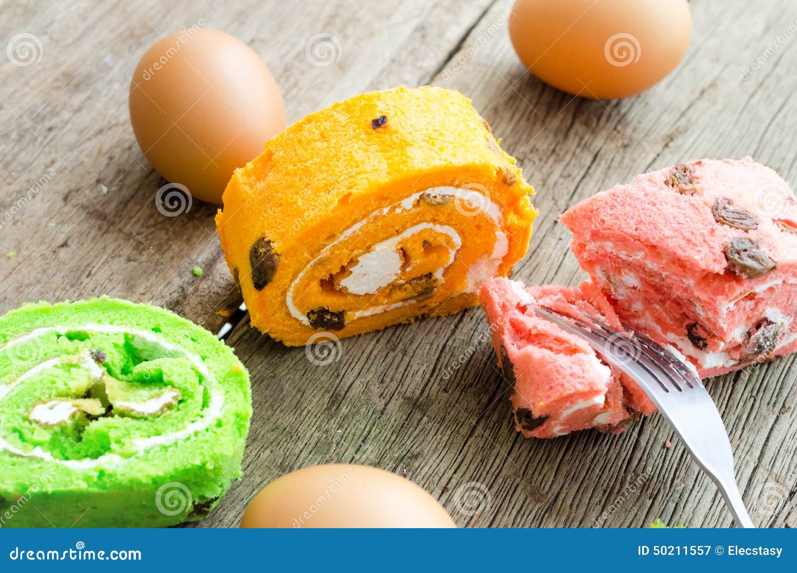 Bright Rolled Cake of Different Color on Wooden Table Stock Image ...
