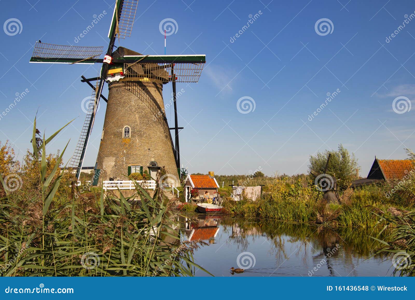 Bright Scenery of a Countryside with a Big Windmill at the Shore of a ...